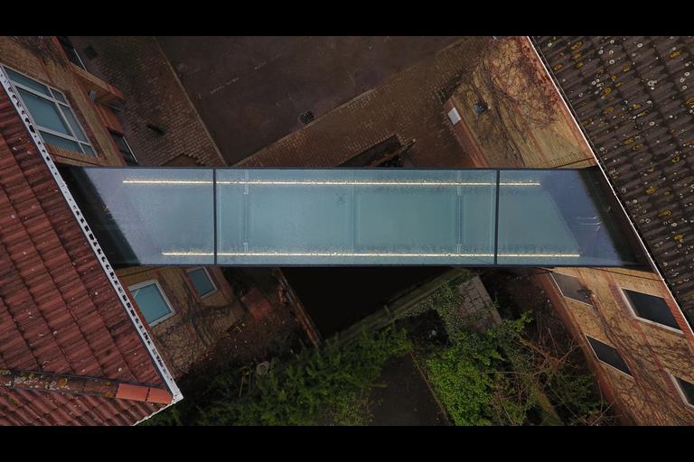Paul Vick Architects completes 15m-long glass bridge for global ...